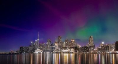 aurora dancing above the Toronto skyline i by Lei Yang